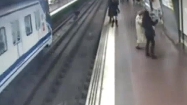 WATCH: Heroic woman drags man from railway line moments before a train ...