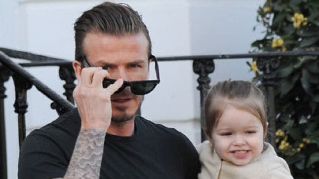 Harper flashes an adorable grin as she steps out with David Beckham ...