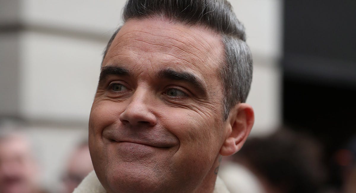 Robbie Williams has a massive tattoo of his own face and it’s certainly ...